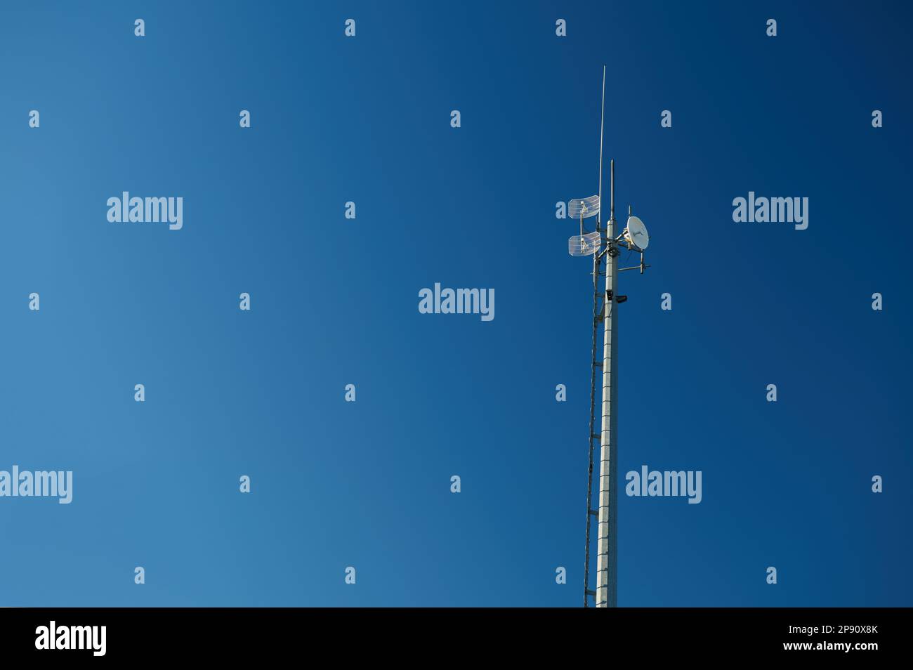 Tall white radio mast against the blue sky Stock Photo - Alamy