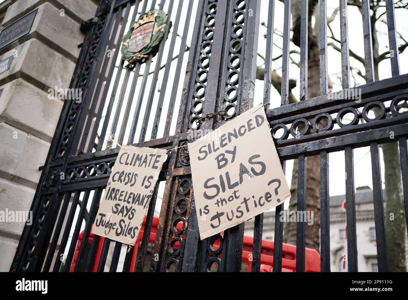 Signs left by Insulate Britain supporters on the gates at Inner London ...
