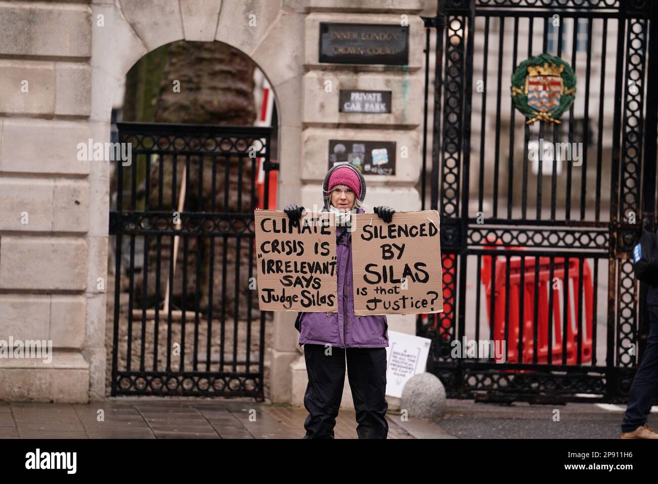 An Insulate Britain supporter protests outside Inner London Crown Court ...