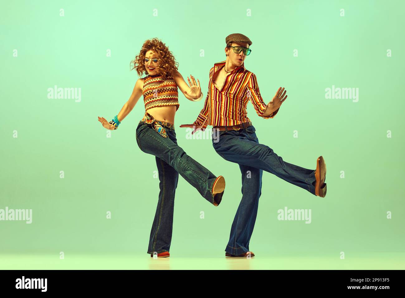 Dynamic portrait of happy man and woman in retro colored shirts and ...