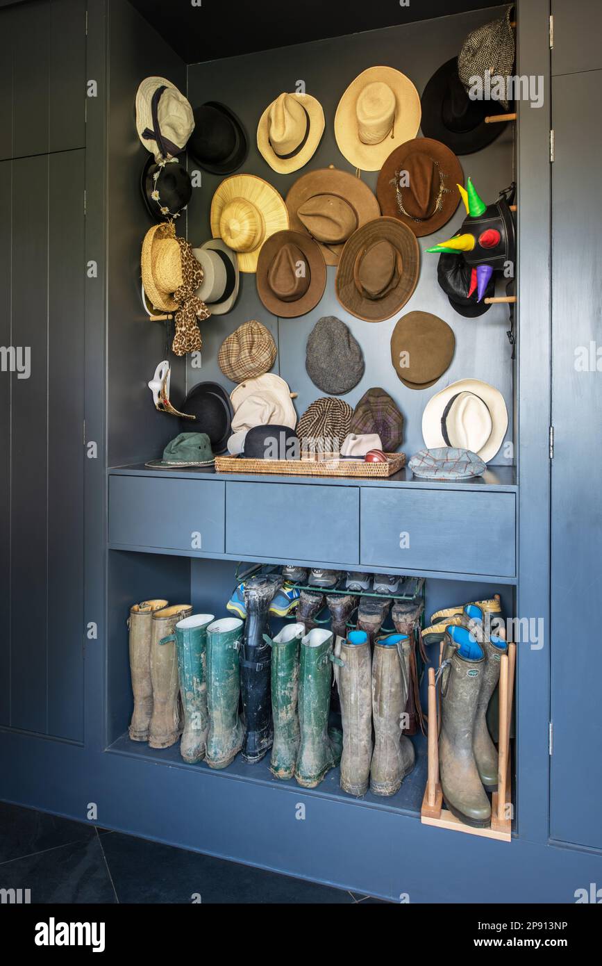 Collection of hats and boots in custom-built cabinet. Contemporary ...