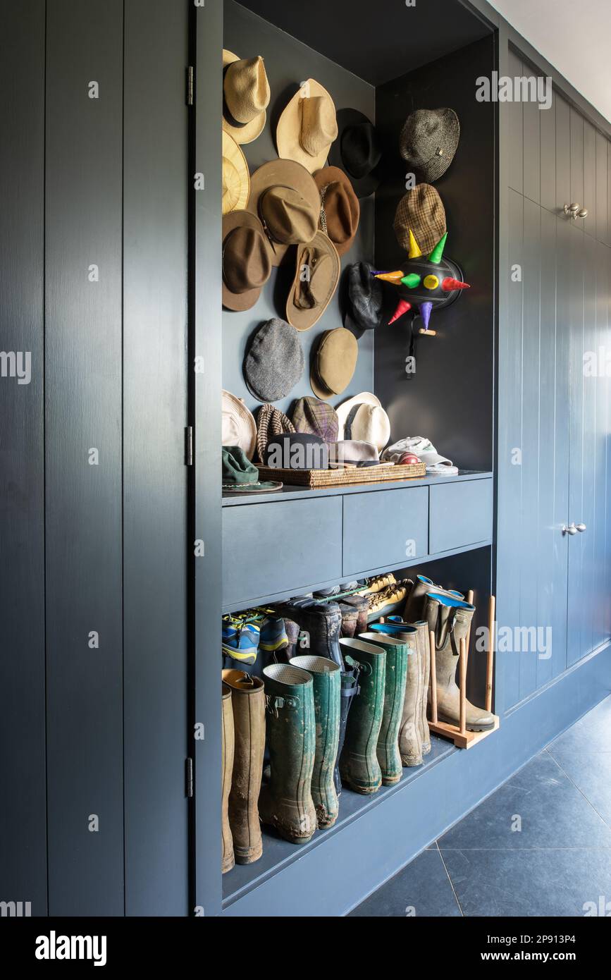 Collection of hats and boots in custom-built cabinet. Contemporary ...