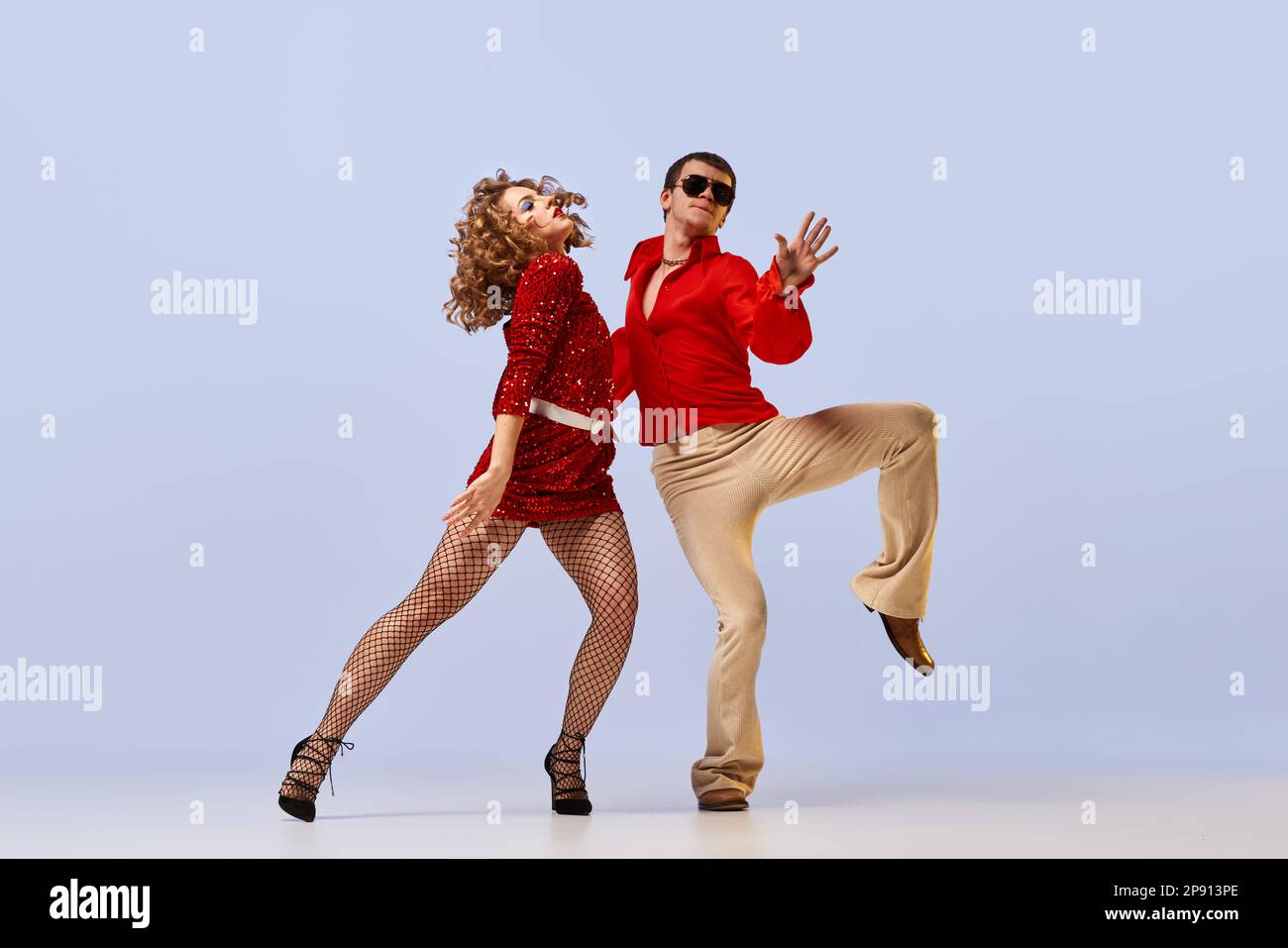 Disco ballroom dances. Expressive couple of dancers in bright retro ...