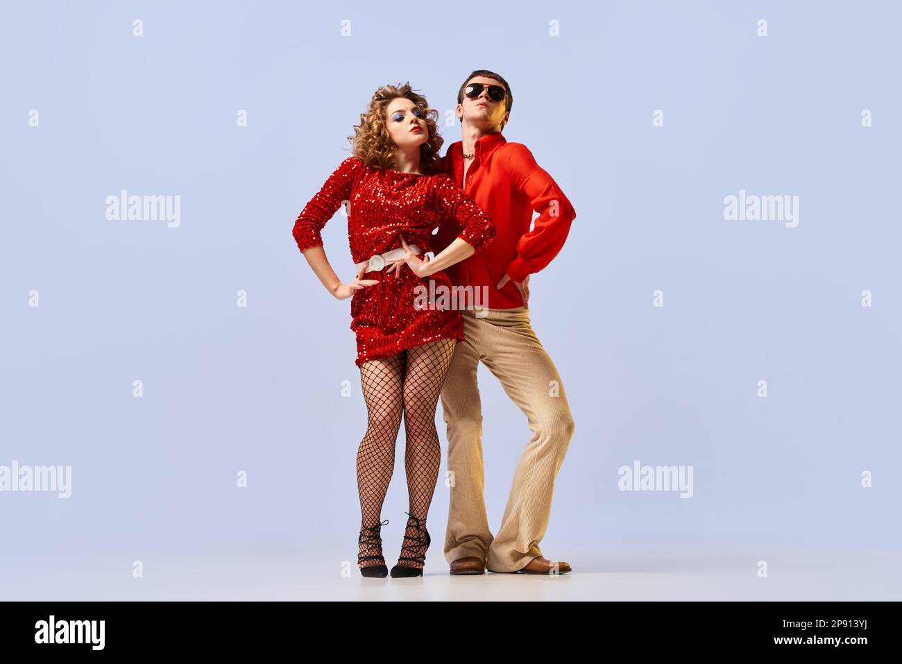 Young beautiful couple of dancers in bright retro fashion clothes ...