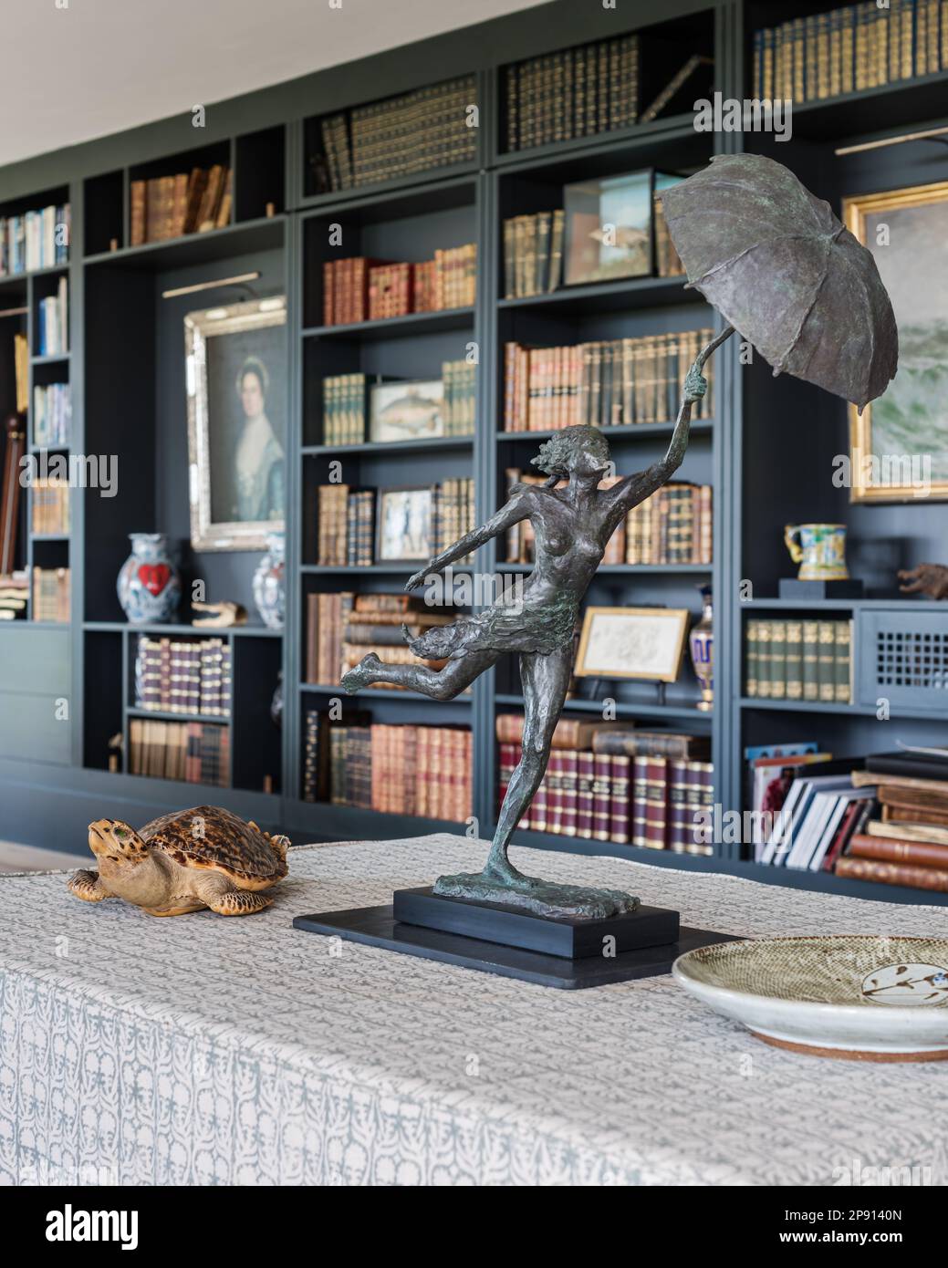 David Williams-Ellis Elemental sculpture with feature wall of shelving ...