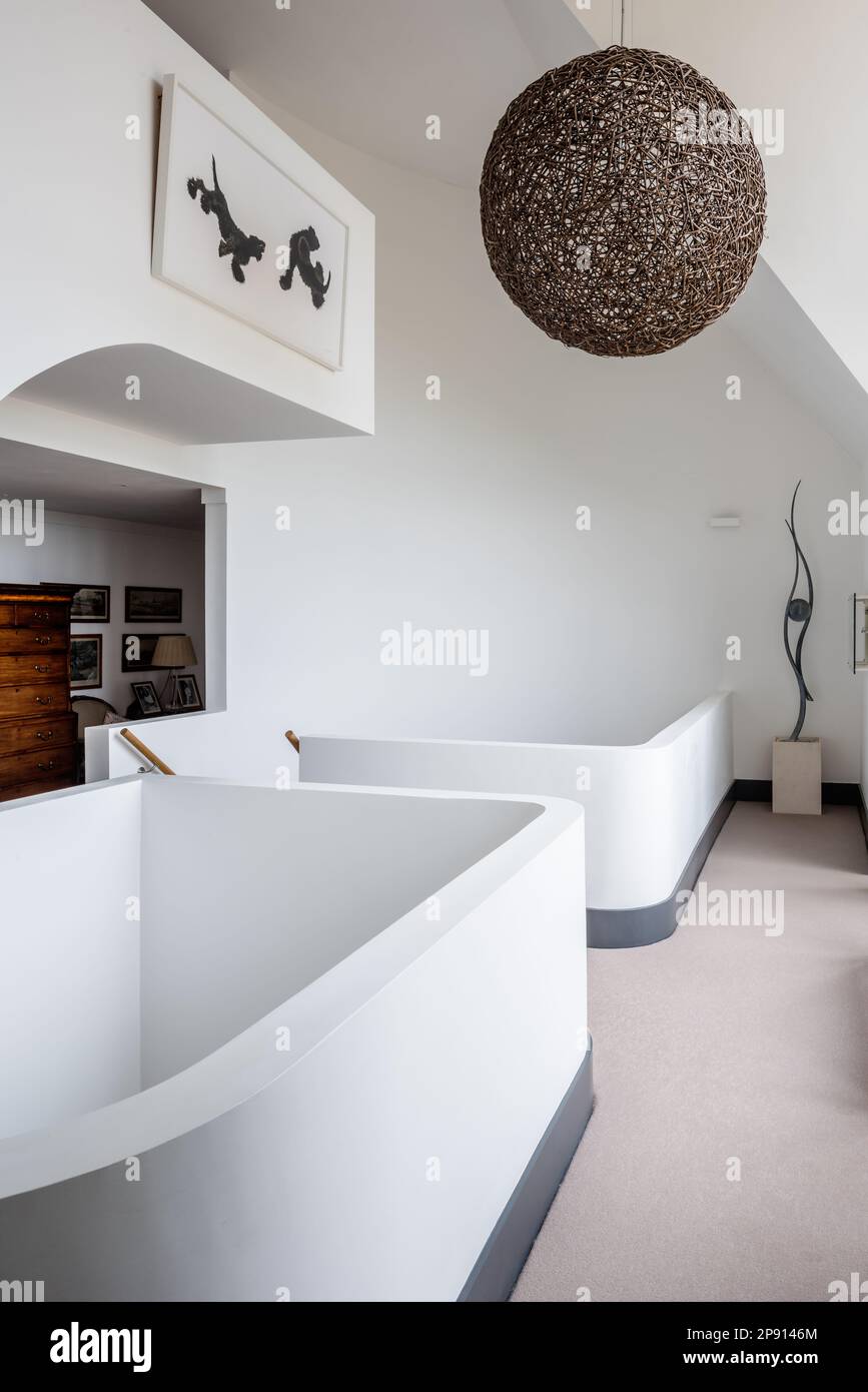 Large wicker pendant in dramatic double height staircase in newly built ...