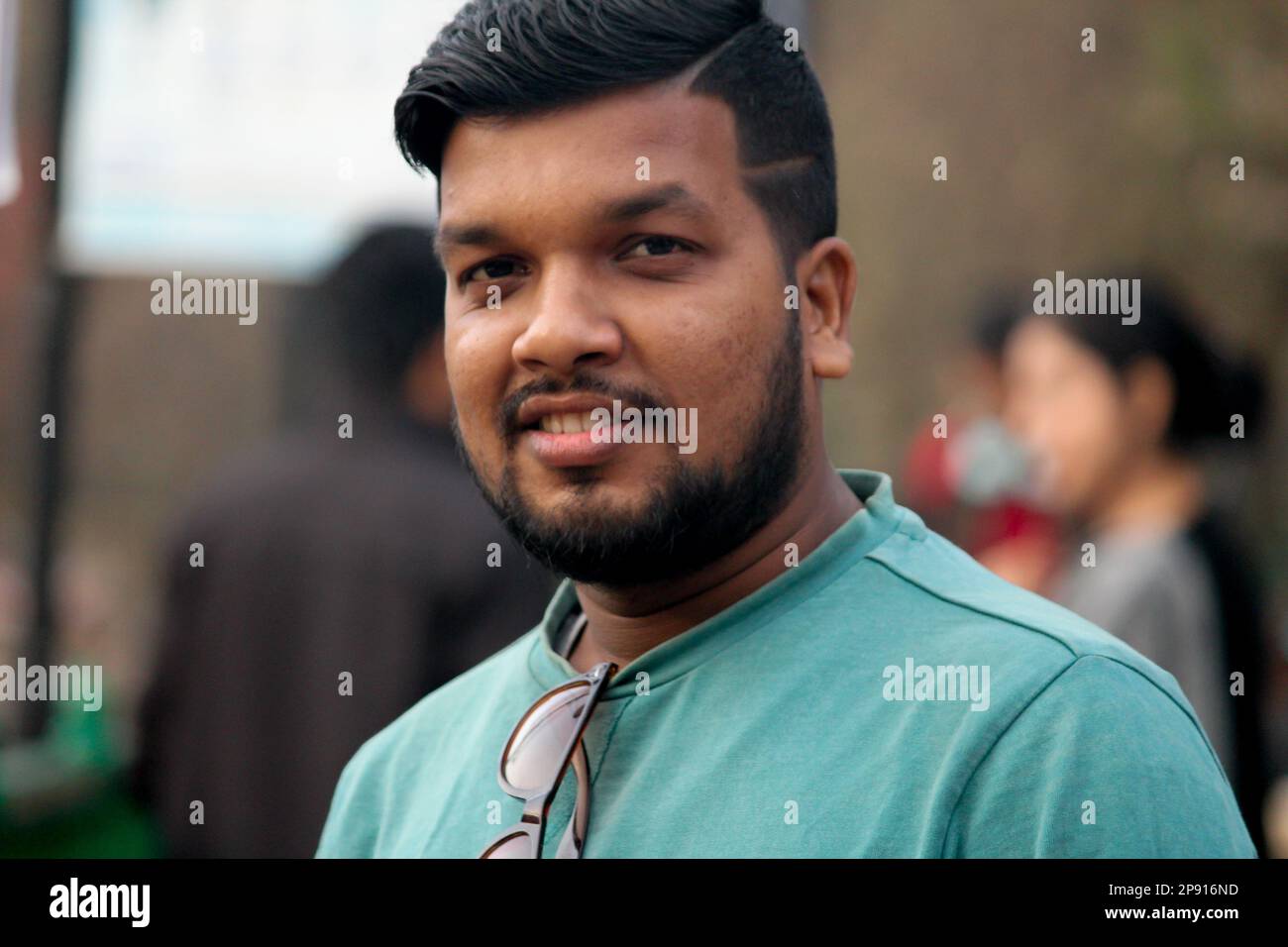 An Indian male stands facing the camera while smiling Stock Photo - Alamy