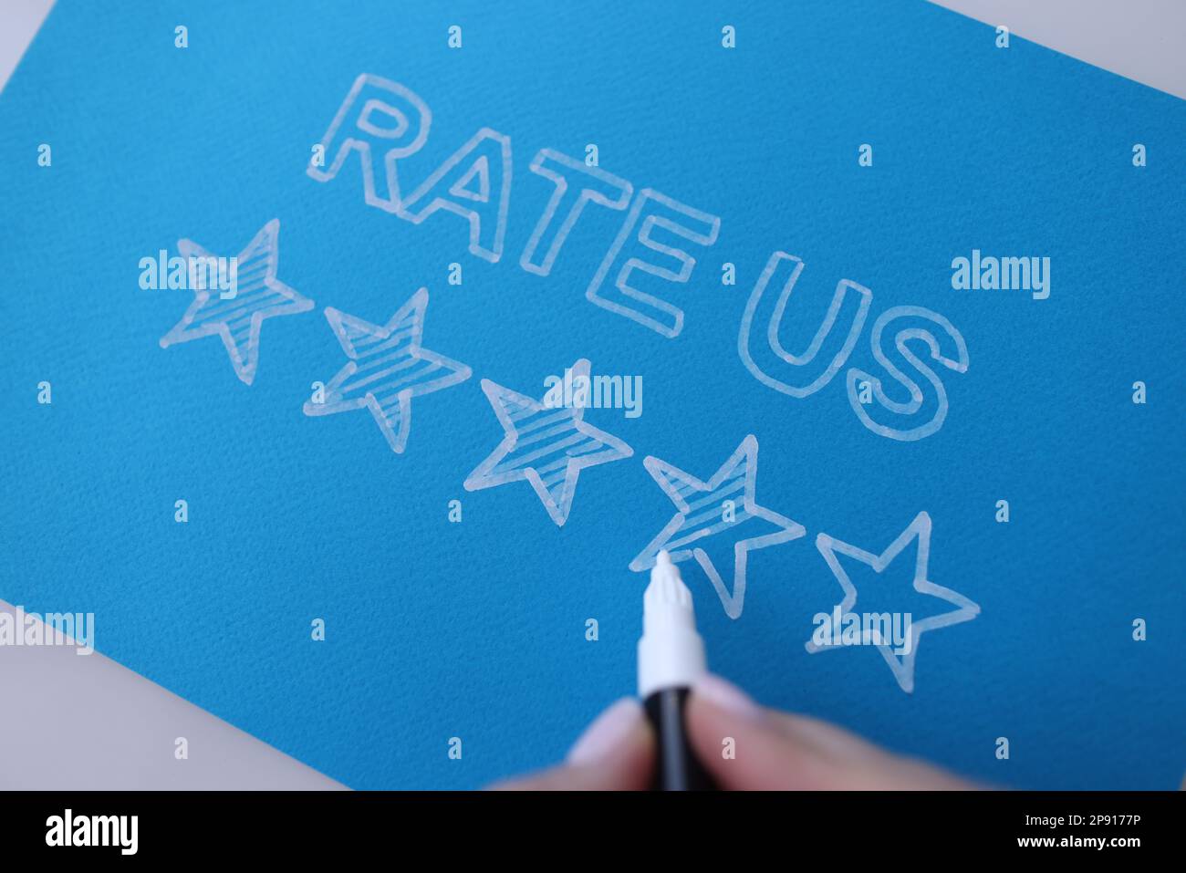 Handwritten review rate us and star rating on blue background Stock ...