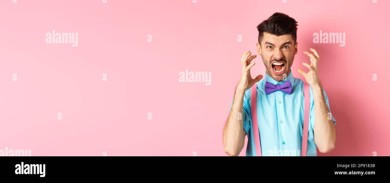 Frustrated young man losing temper, screaming and looking angry at ...