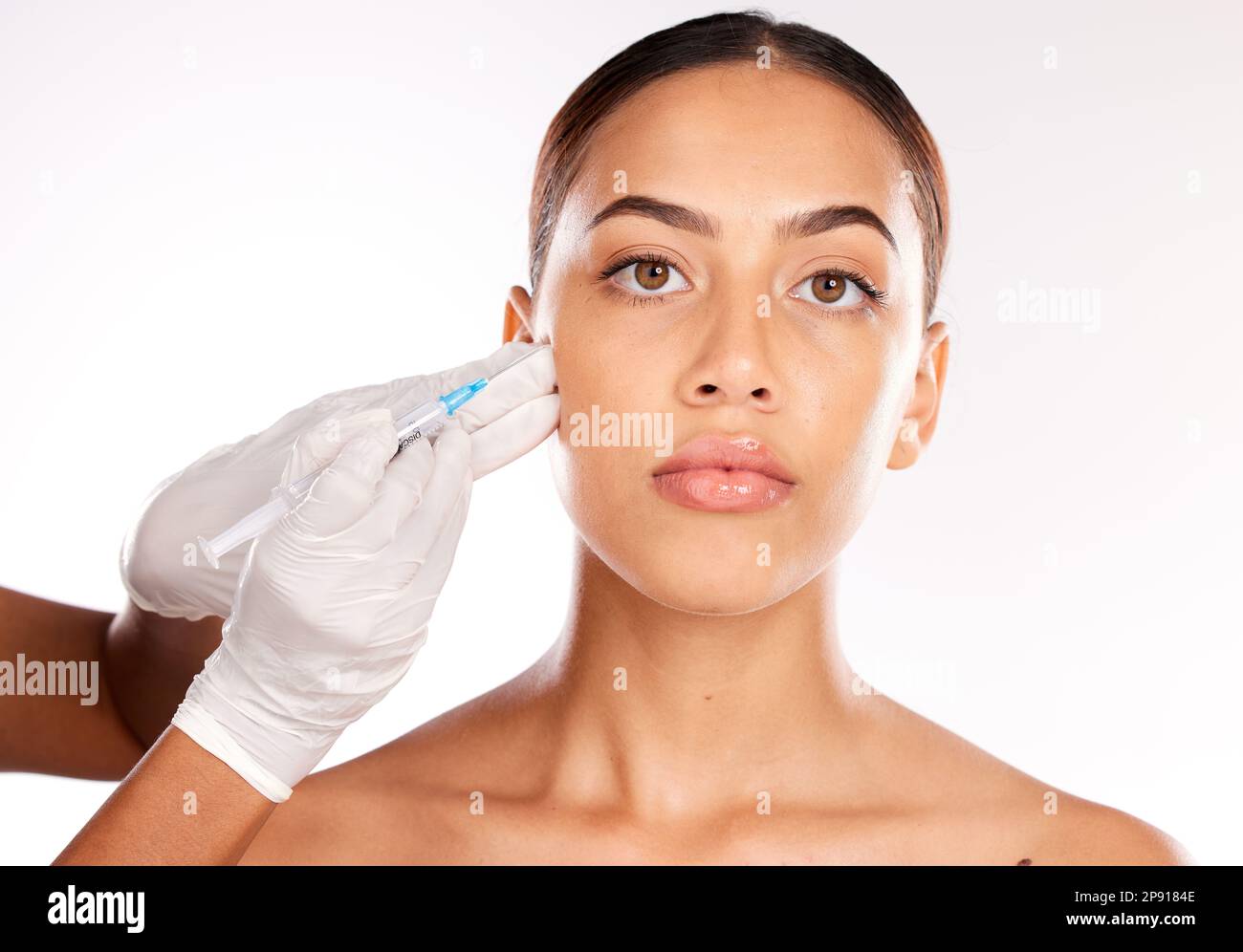 Botox, face and injection of woman and plastic surgery hands in studio ...