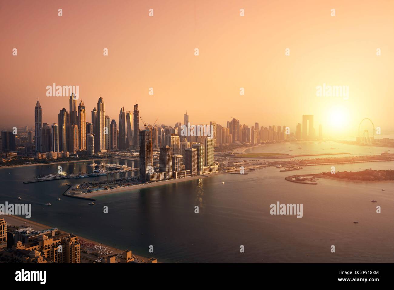 Dubai skyline on sunset, modern city with skyscrapers seen from water ...
