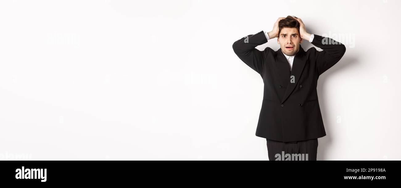 Frustrated and worried businessman in black suit, panicking as looking ...