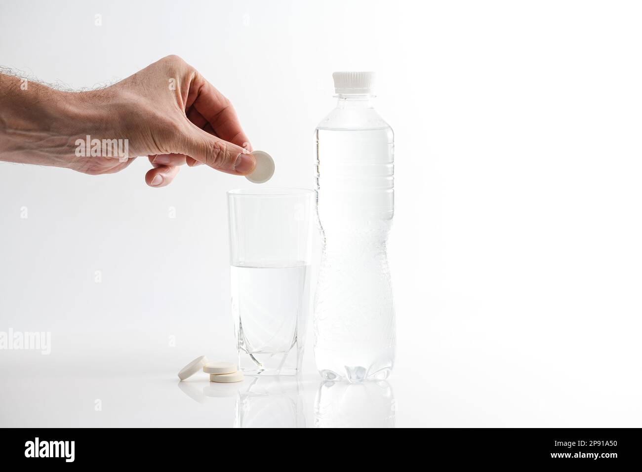 A hand holding effervescent soluble calcium tablet or vitamin C is ...