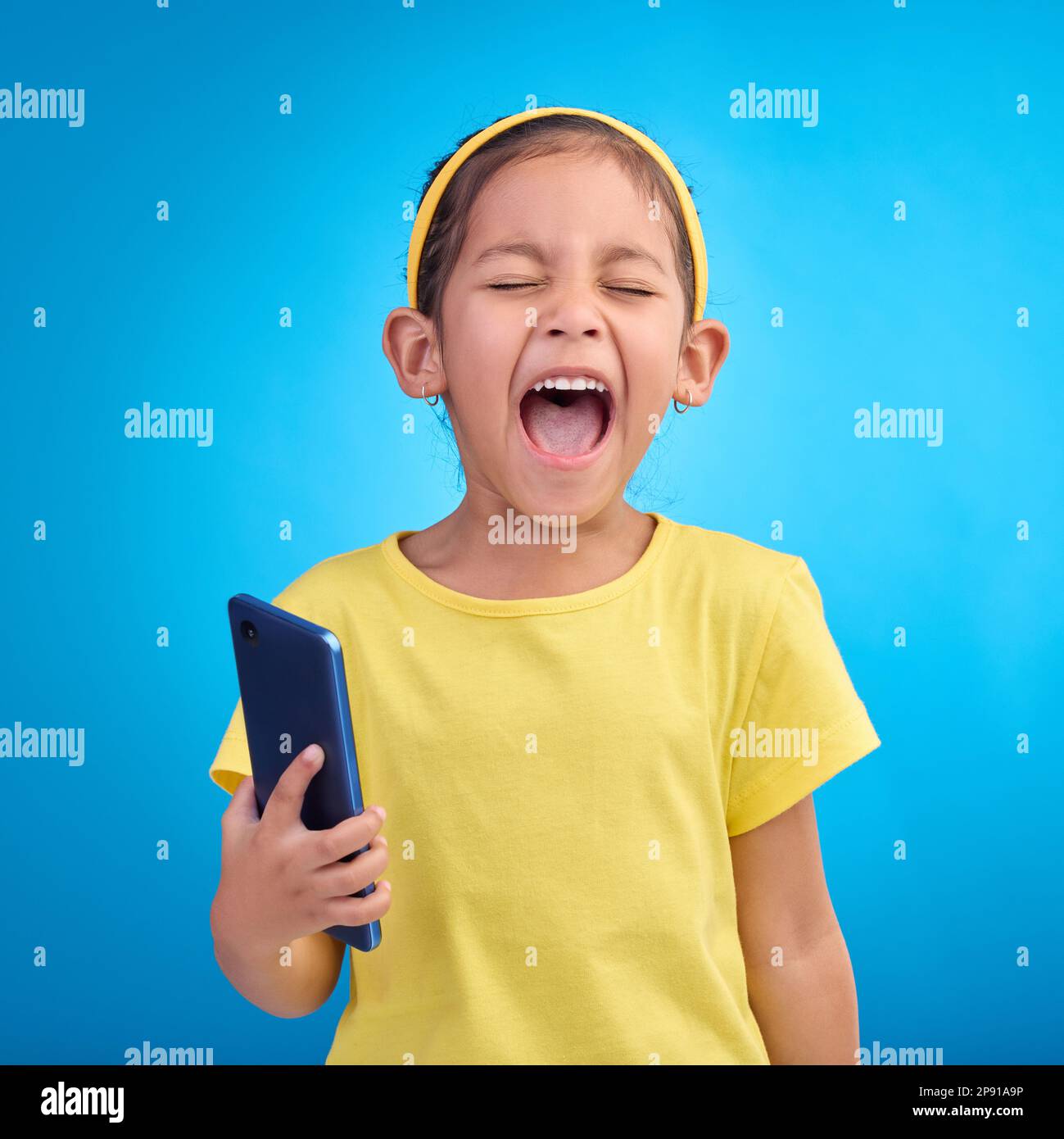 Phone, scream and child on blue background with attitude, upset and ...