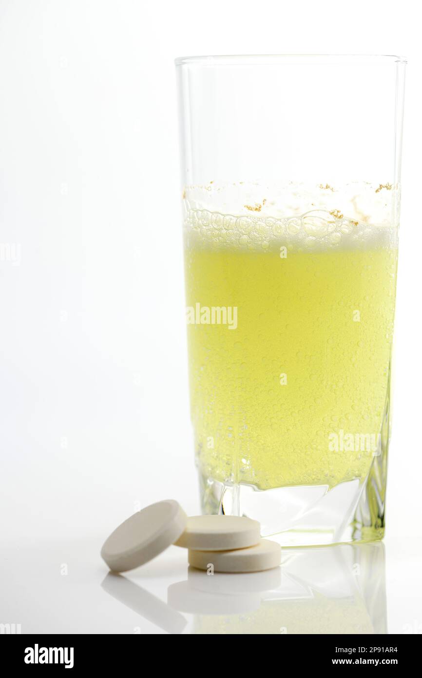 The effervescent tablet dissolves in a glass of water. Close-up Stock ...