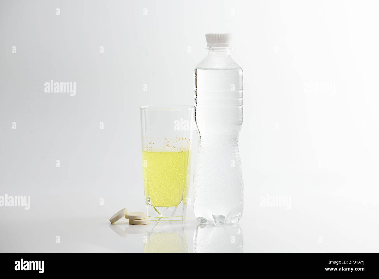 The effervescent tablet dissolves in a glass of water. Glass with ...