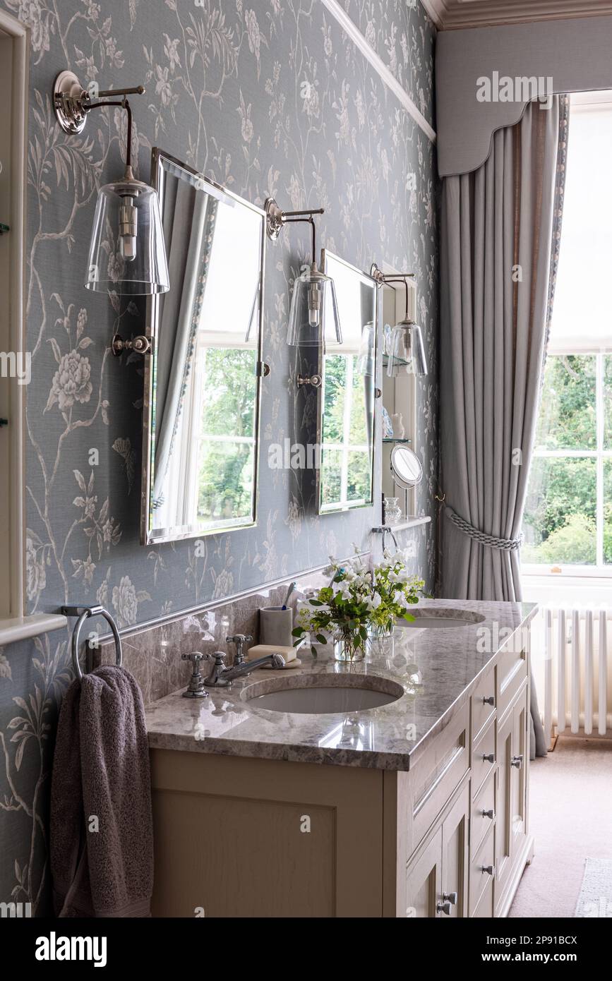 Double basins and mirrors with Colefax and Fowler wallpaper in 18th ...