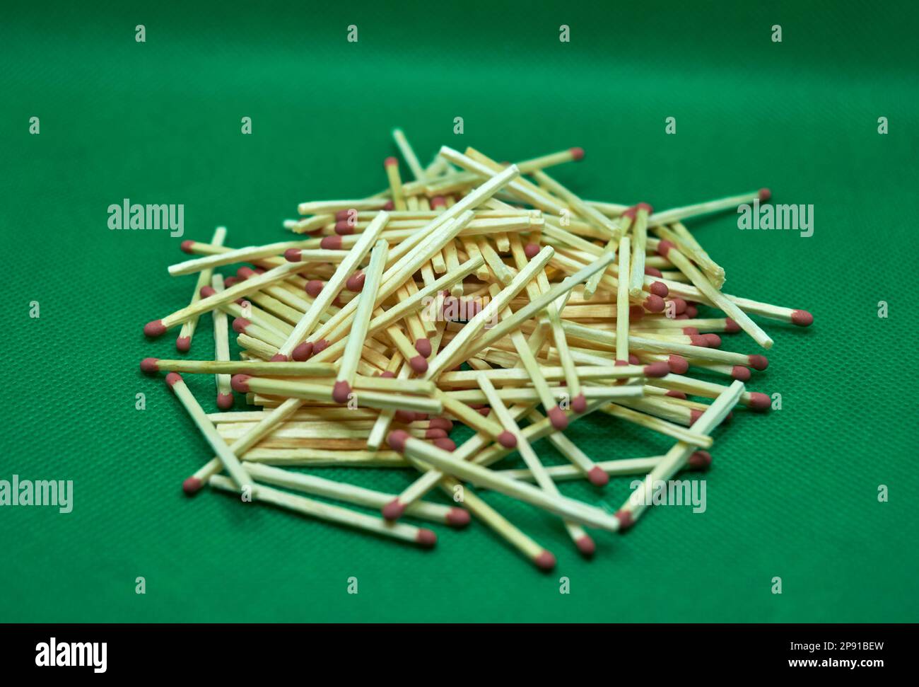 A pile of matches on a green background, selective focus Stock Photo ...