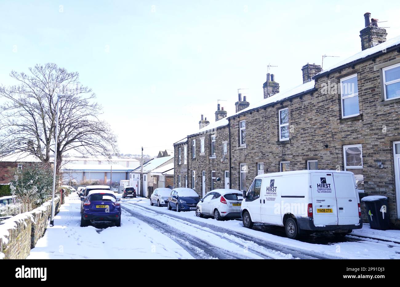 Snow covers cars and a small street in Cleckheaton, West Yorkshire ...