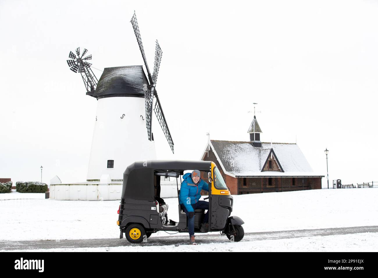 Lytham, UK. A man poses for a photograph in his rickshaw vehicle in ...