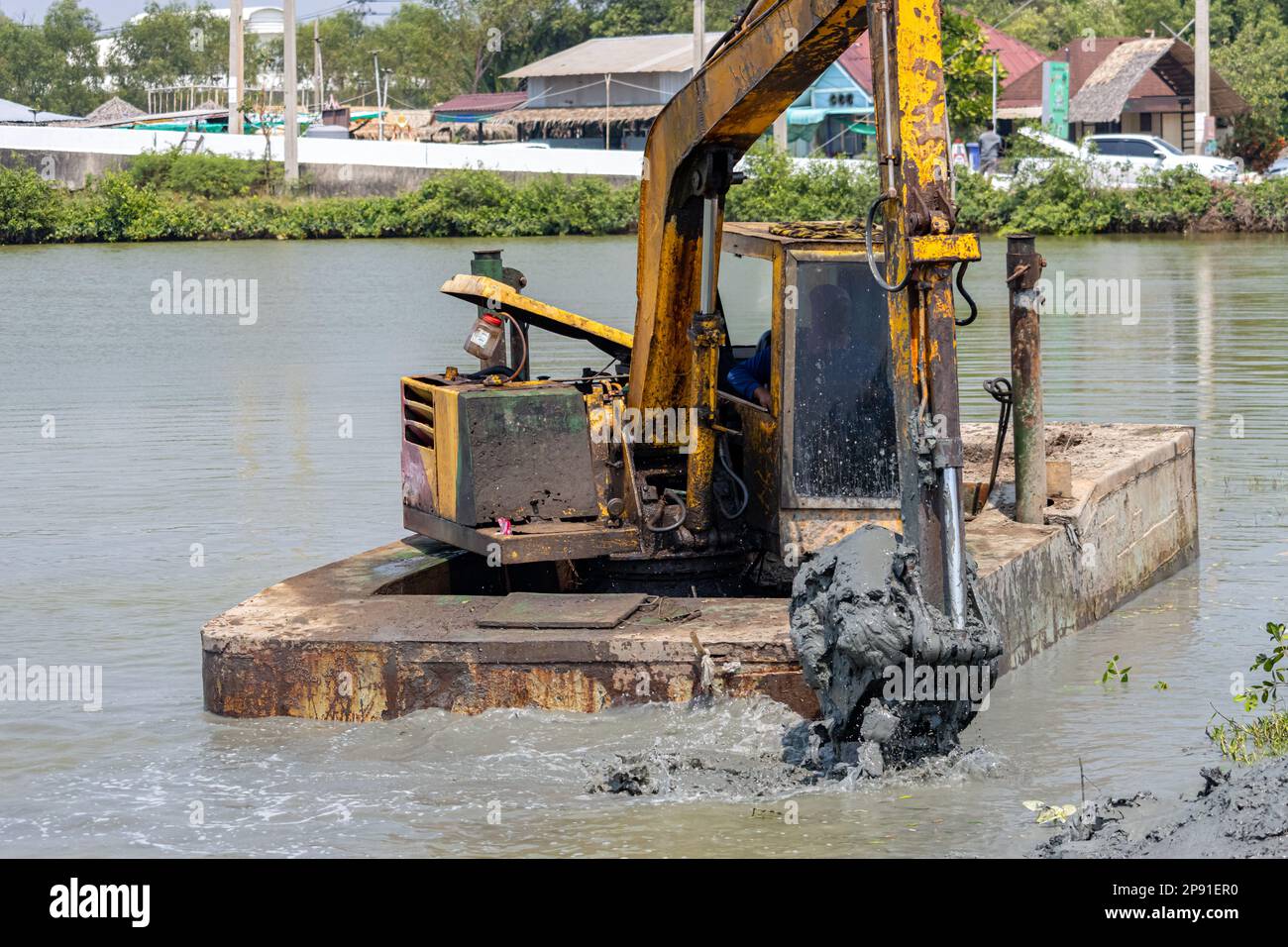 A floating dredger is dredging the bottom of the pond, Thailand Stock ...