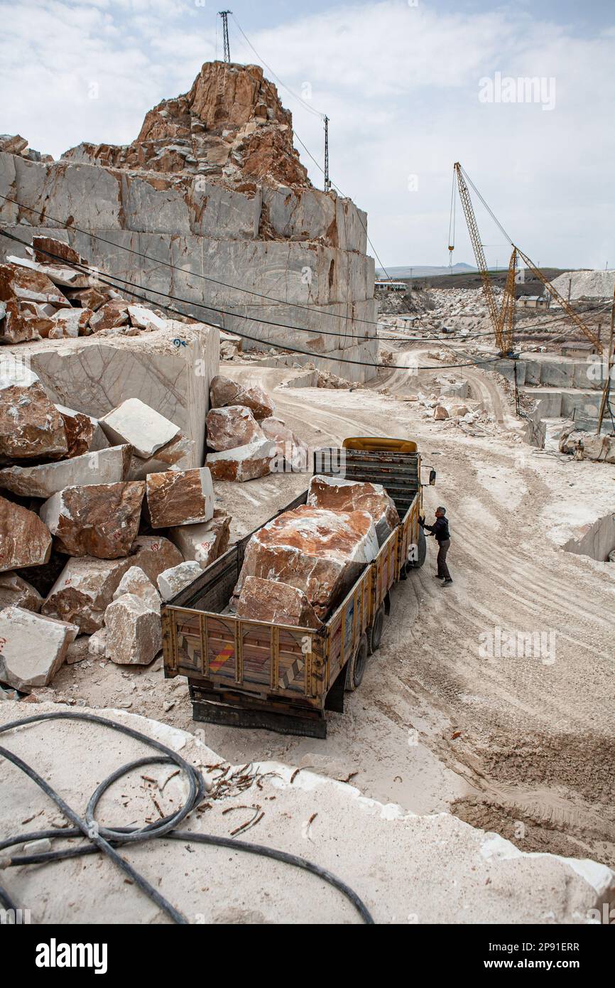 A truck driver closes the covers of her loaded vehicle and sets off ...