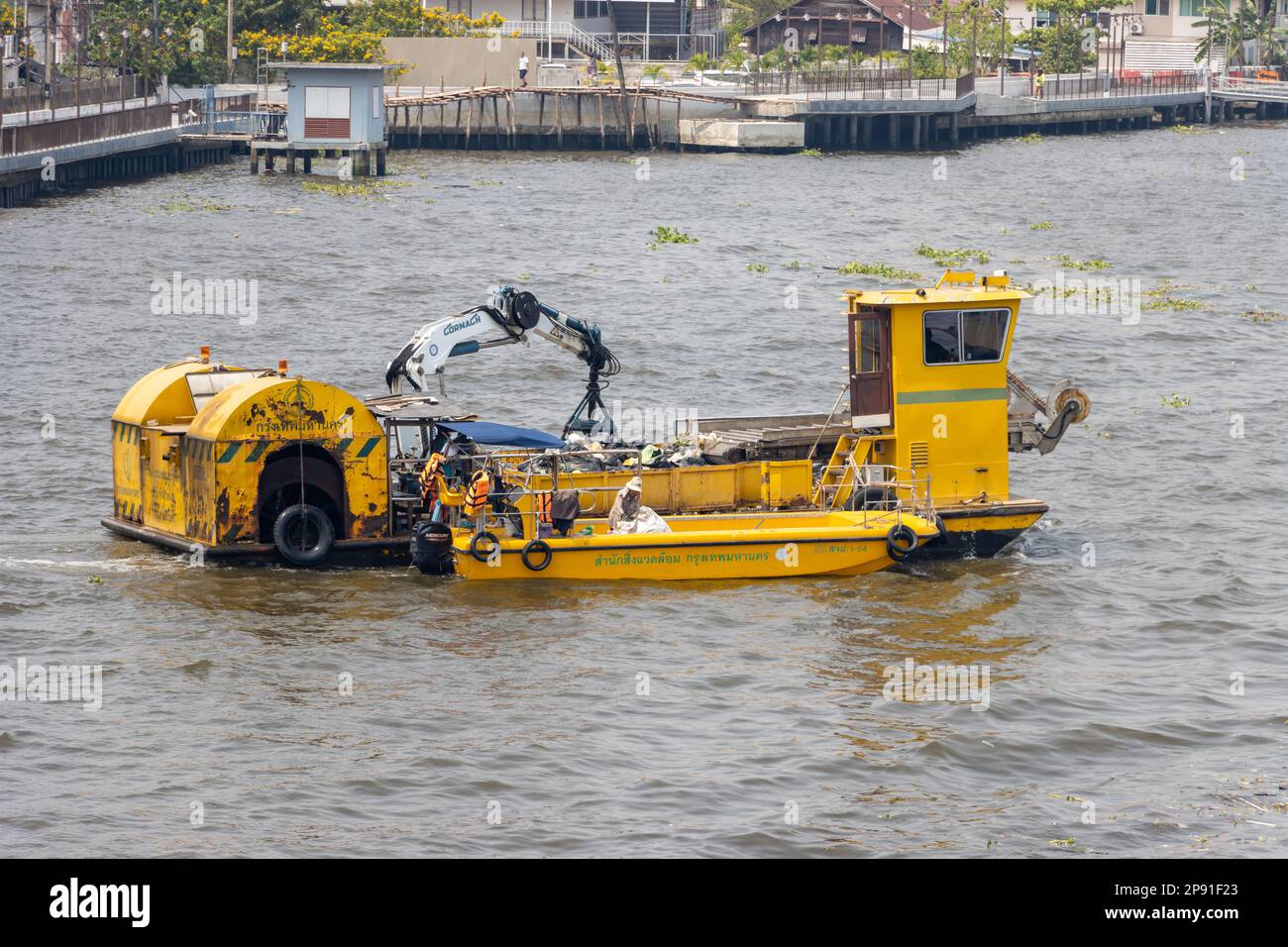 BANGKOK, THAILAND, MAR 06 2023, A trash-cleaning boat collect the ...