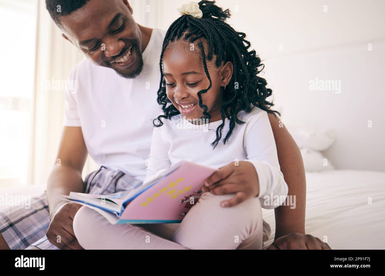 Black family, children and a father reading to his daughter in the ...