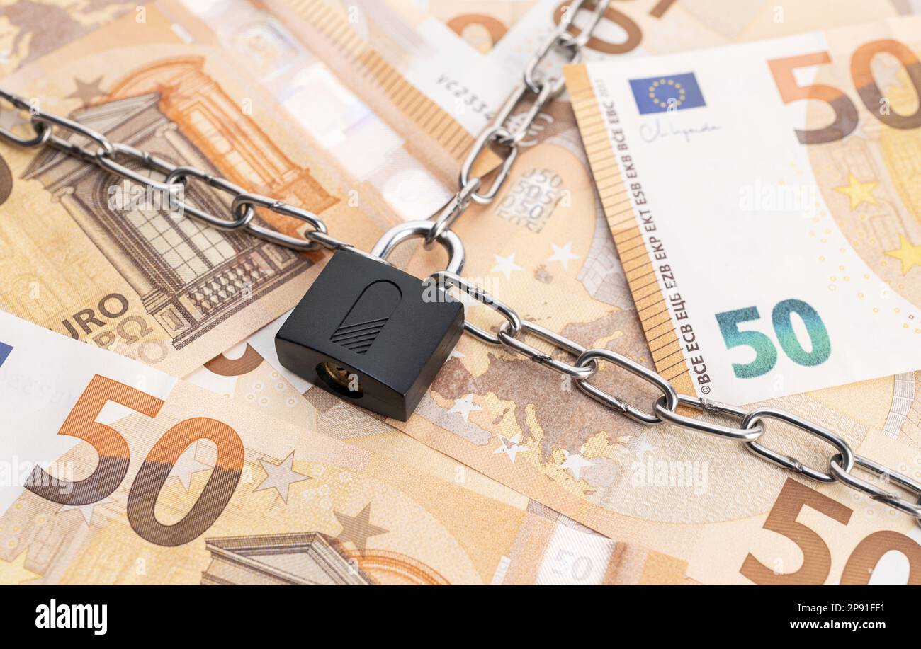 Lock security and chain on euro banknotes background. Monetary crisis ...