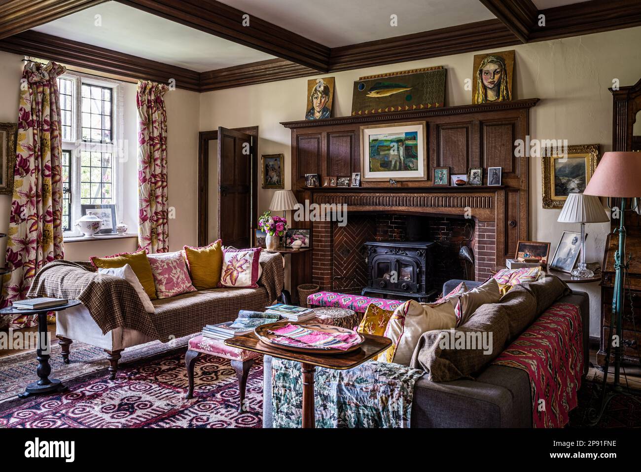 Artwork and mixed patterns at fireside in Wiveton Hall 17th century ...