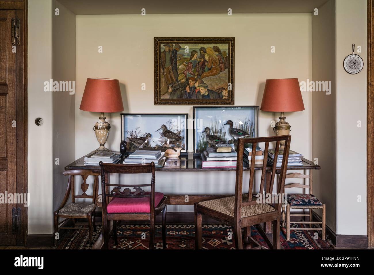 Pair of lamps and taxidermy with artwork on desk in Wiveton Hall 17th ...