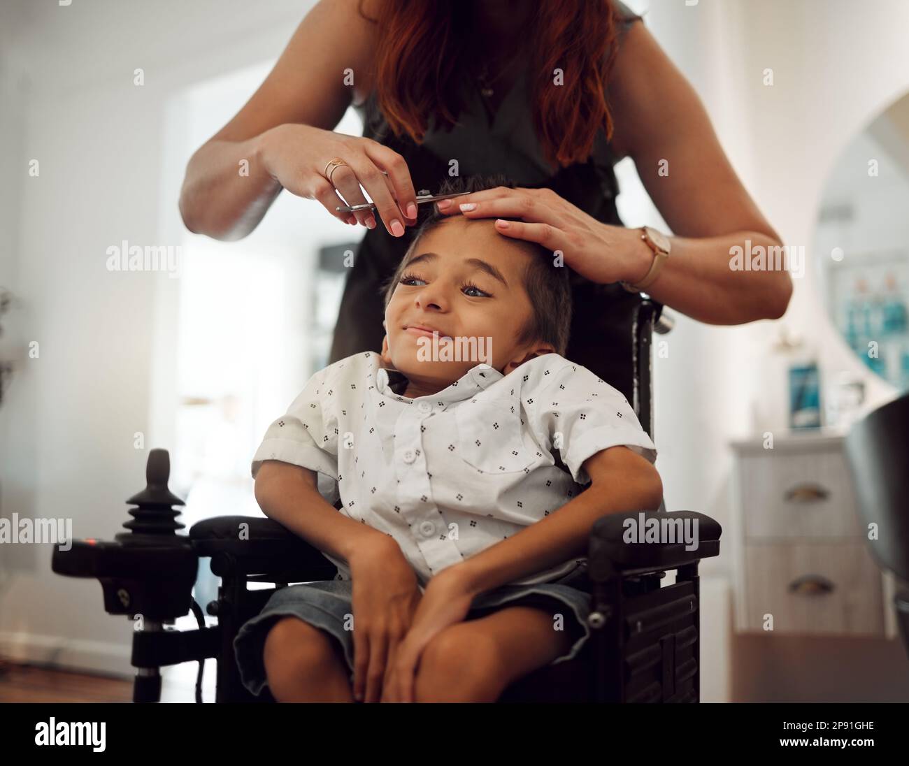 Haircut, special needs and cerebral palsy child at a hairdresser with a smile. Happy kid with a ...
