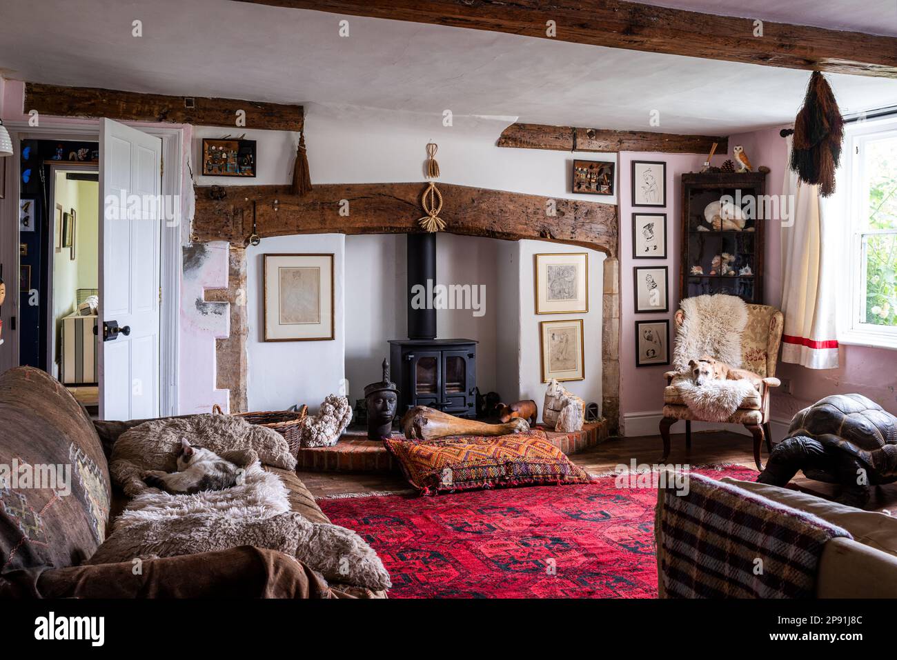 Mixed styles and collectables in living room of 16th century Tudor ...