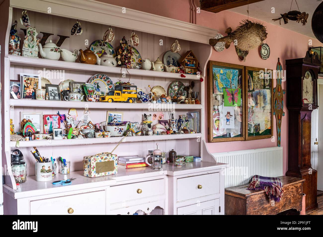 Collection of plates and vintage objects on dresser in kitchen of 16th ...