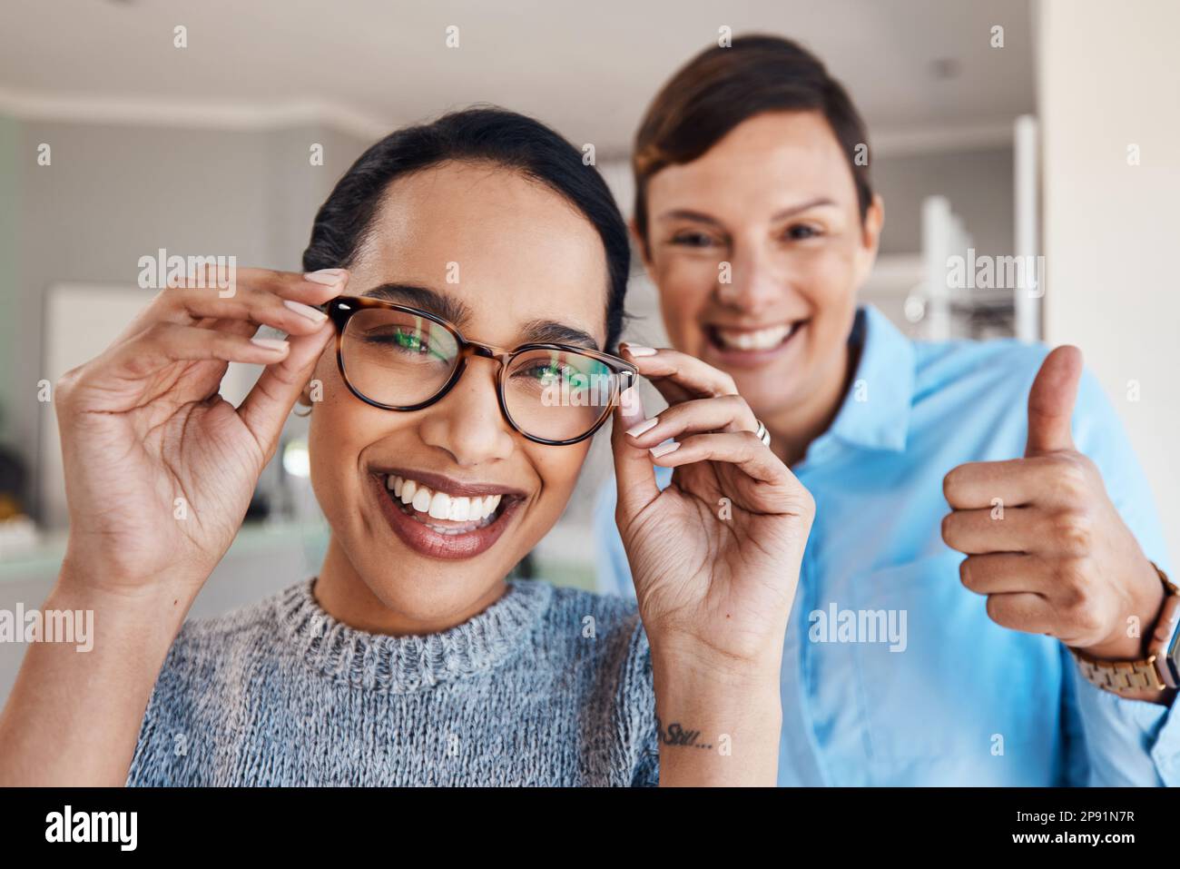 Better vision, better life. Shot of an optometrist giving thumbs after ...