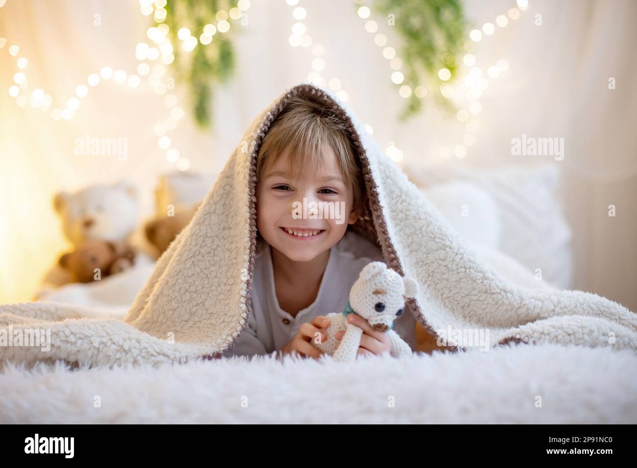 Little cute preschool boy, holding cute teddy bear, hiding under ...