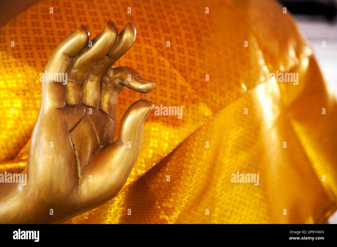 Golden Buddha statue hand gesture close-up with copy space. Asian ...