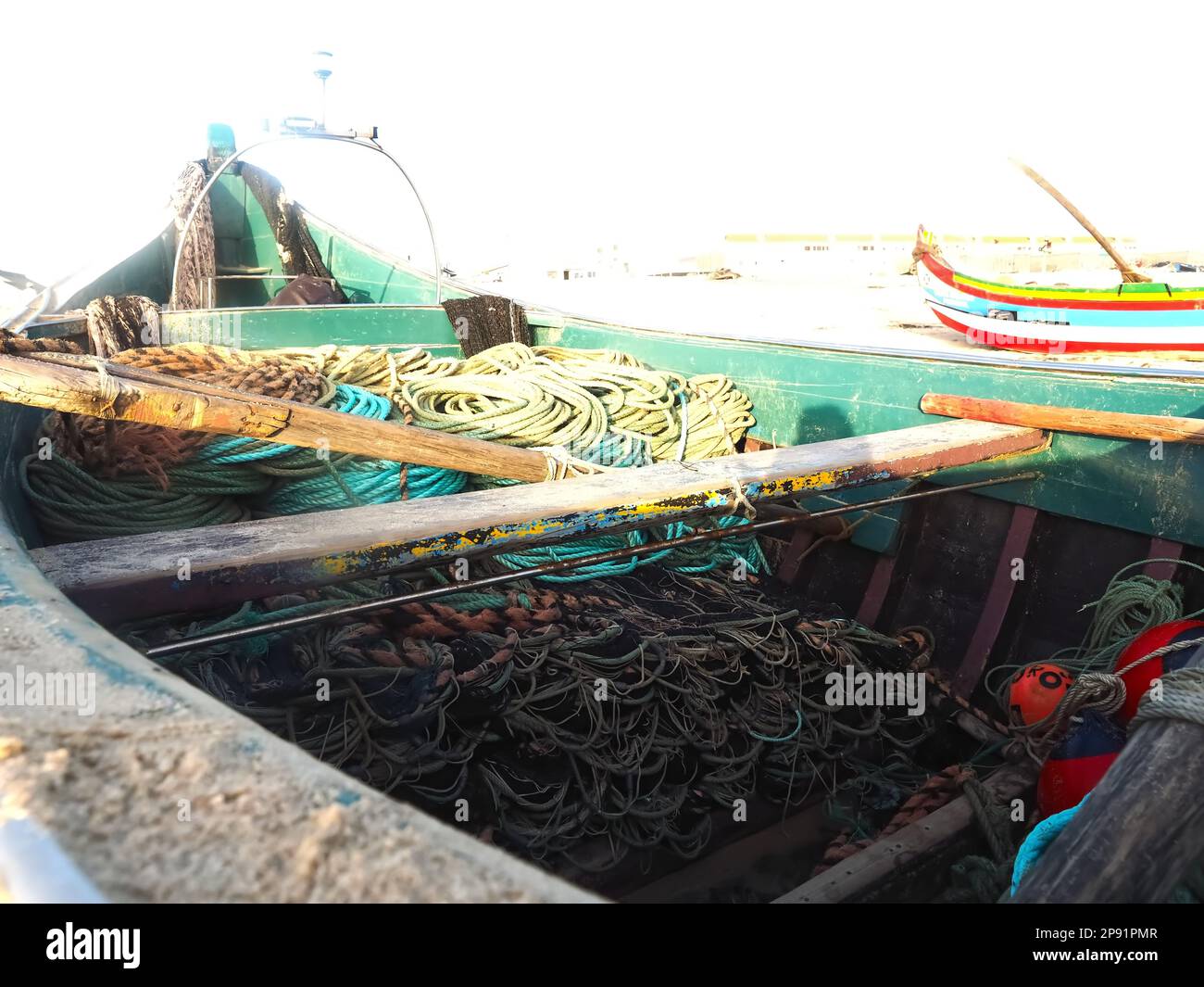 Fisher boat with nets and ropes on a beach Stock Photo - Alamy