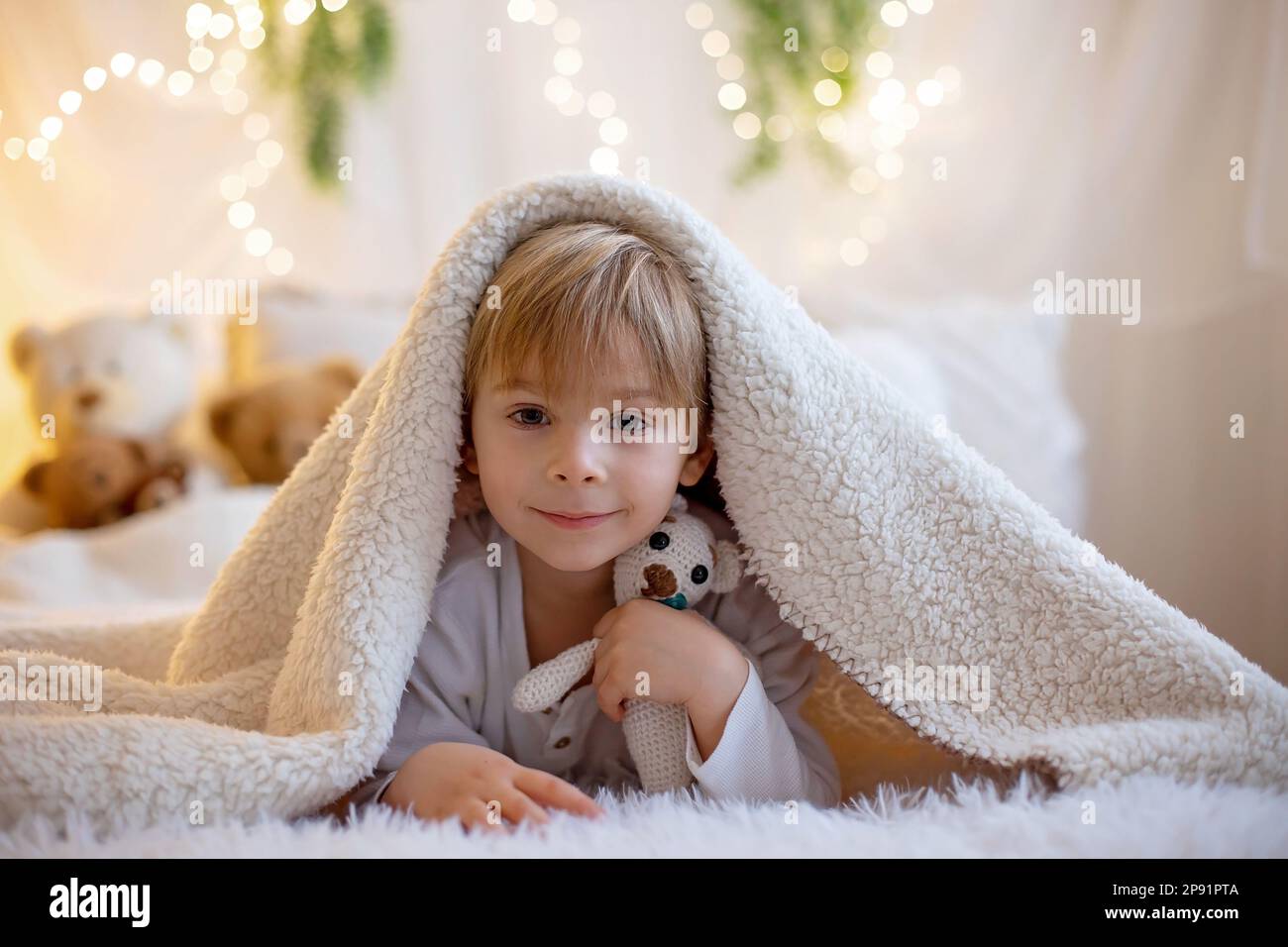 Little cute preschool boy, holding cute teddy bear, hiding under ...