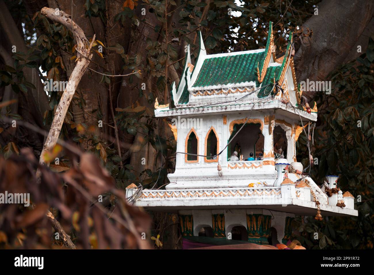 Thai religious green spirit house among trees for worshiping and ...