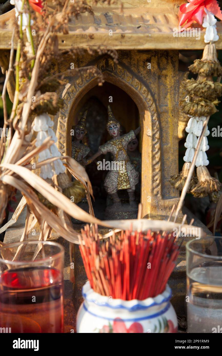 Small spirit house and offering in Thailand close-up. Asian religious ...