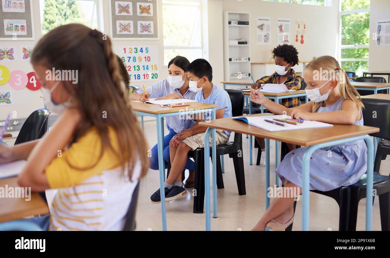 Learning, covid teaching and studying young students sitting in a ...