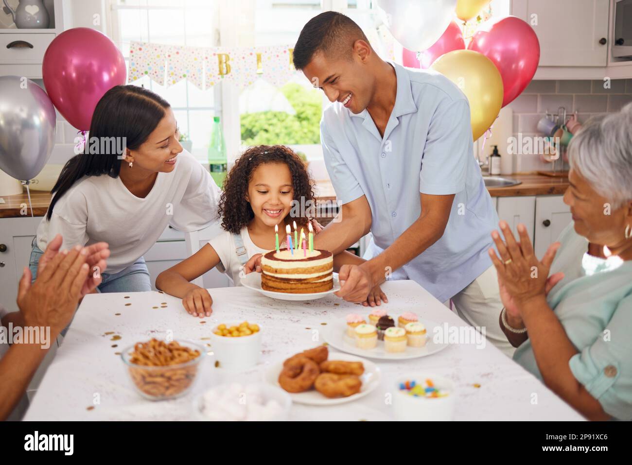 Child, birthday cake and celebration party with family and parents of a ...