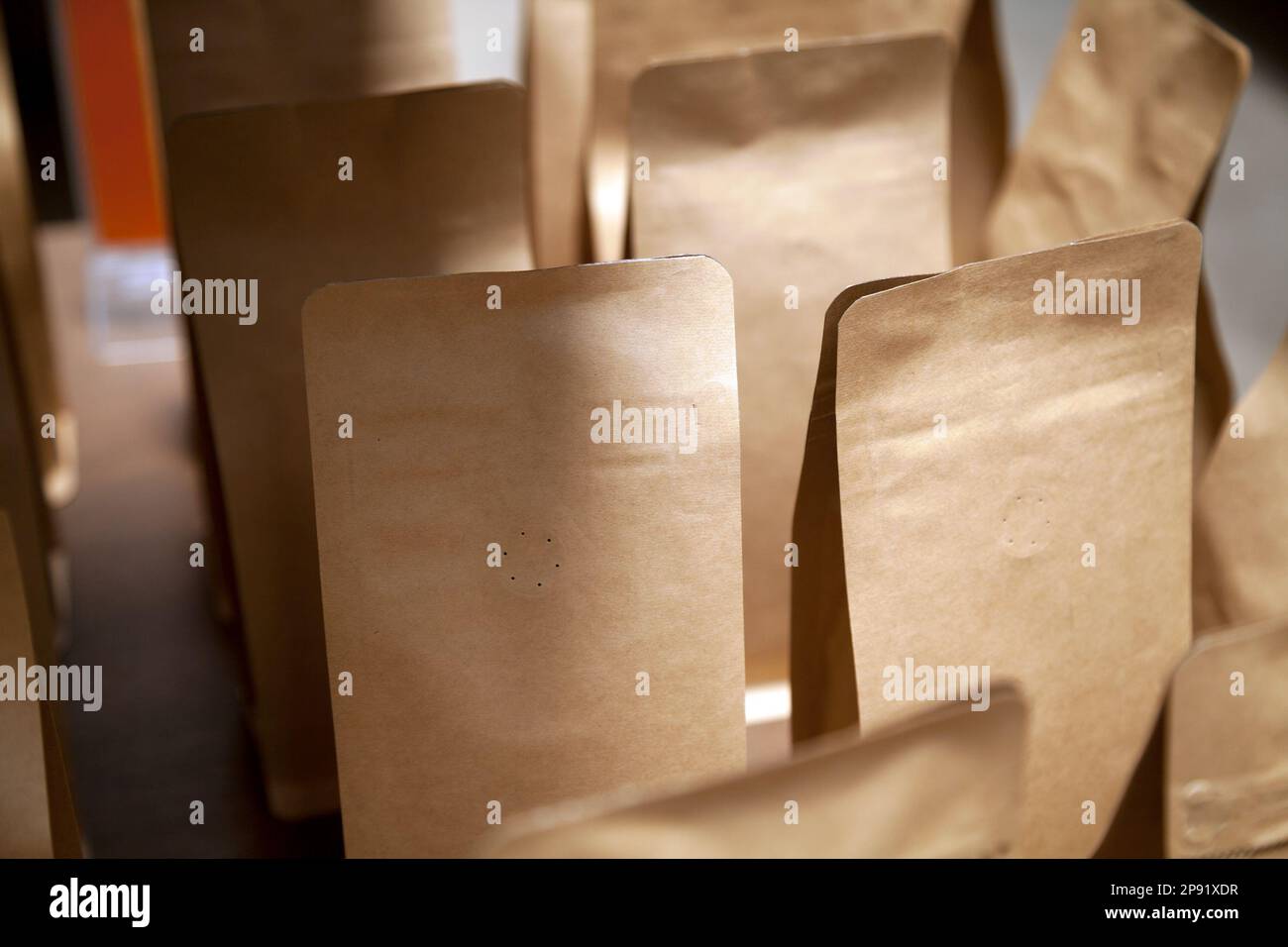 Group of brown kraft paper bags with air vent close-up. Blank retail ...