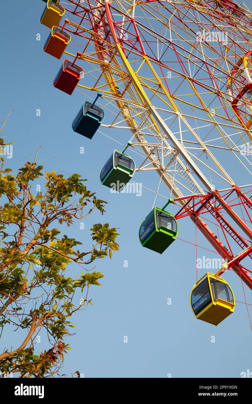 Ferris wheel painted in rainbow colors at amusement park. Colorful ...