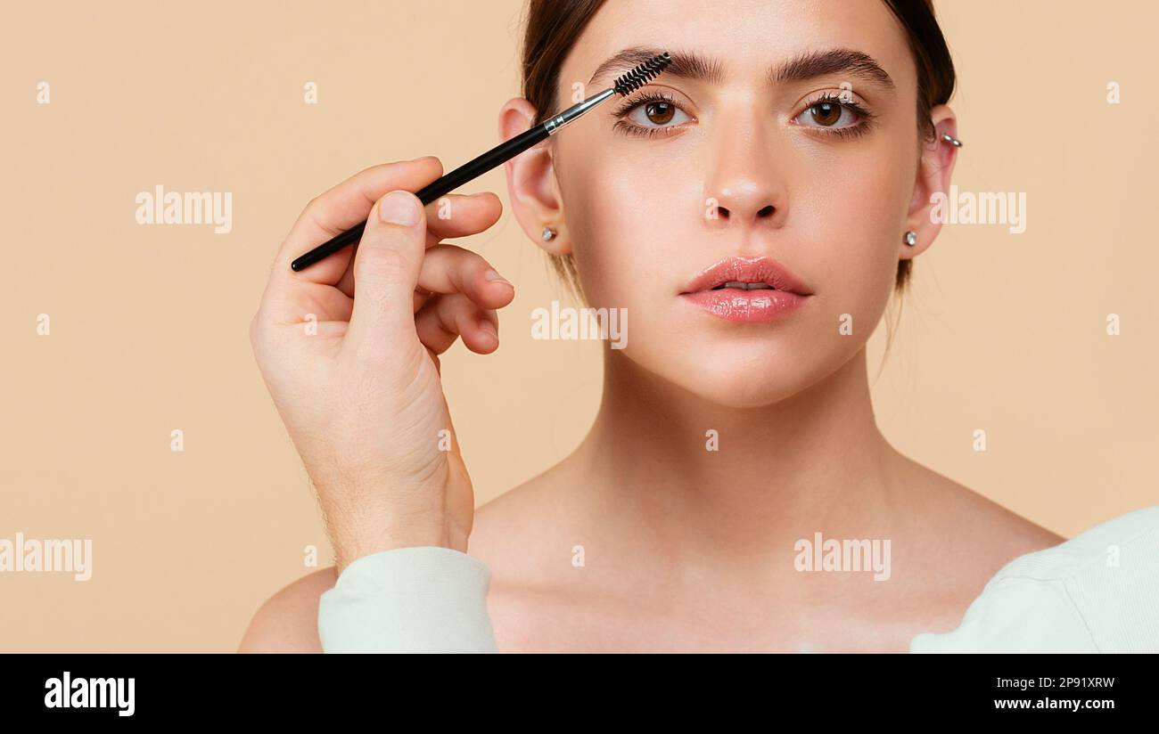 Woman eye with beautiful eyebrows. Perfect shaped brow, eyelashes with brow gel brush. Female ...