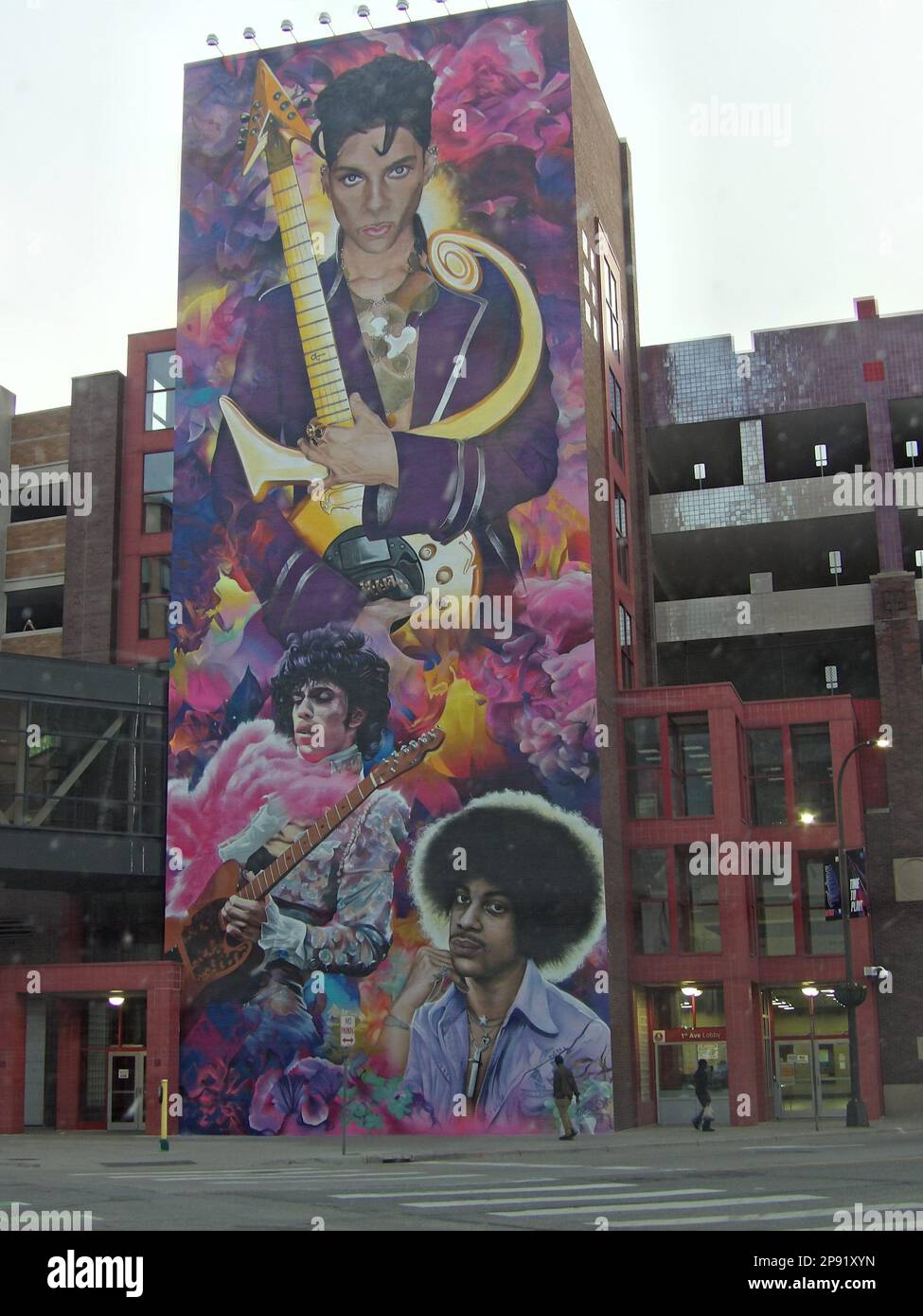 A large colorful mural decorates the side of a brick building ...