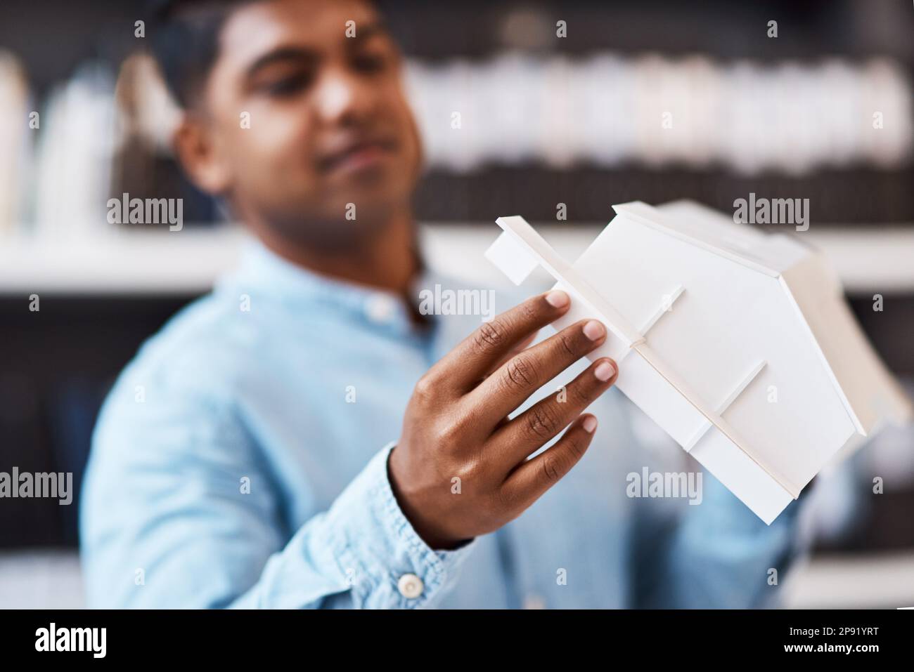 Say hello to your new home. Shot of a young architect designing a ...
