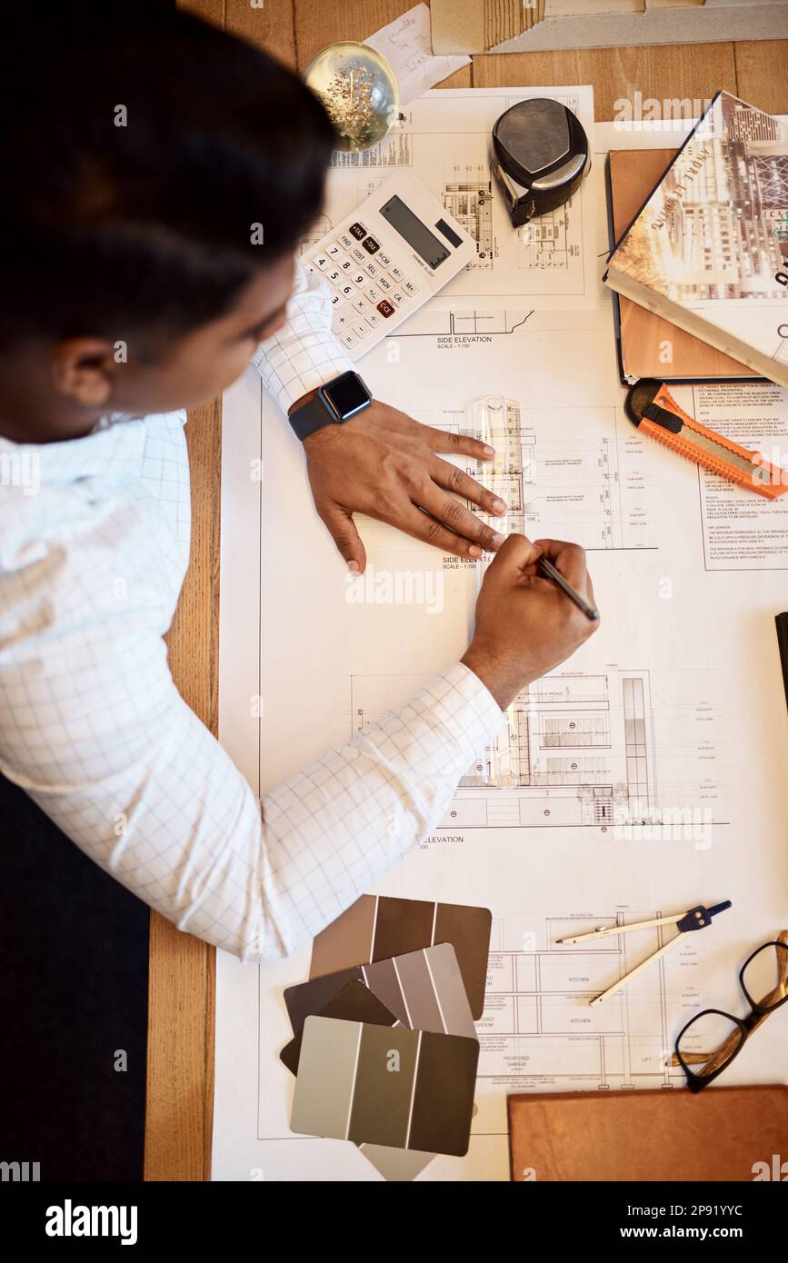 With precision comes perfection. High angle shot of an architect using ...