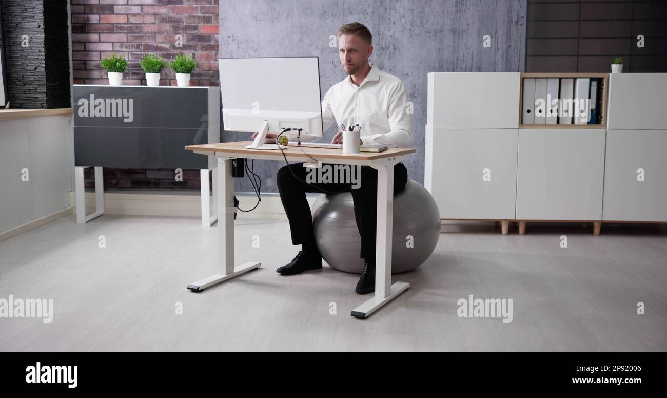 Office Ball Exercise. Sitting Posture At Desk Stock Photo - Alamy